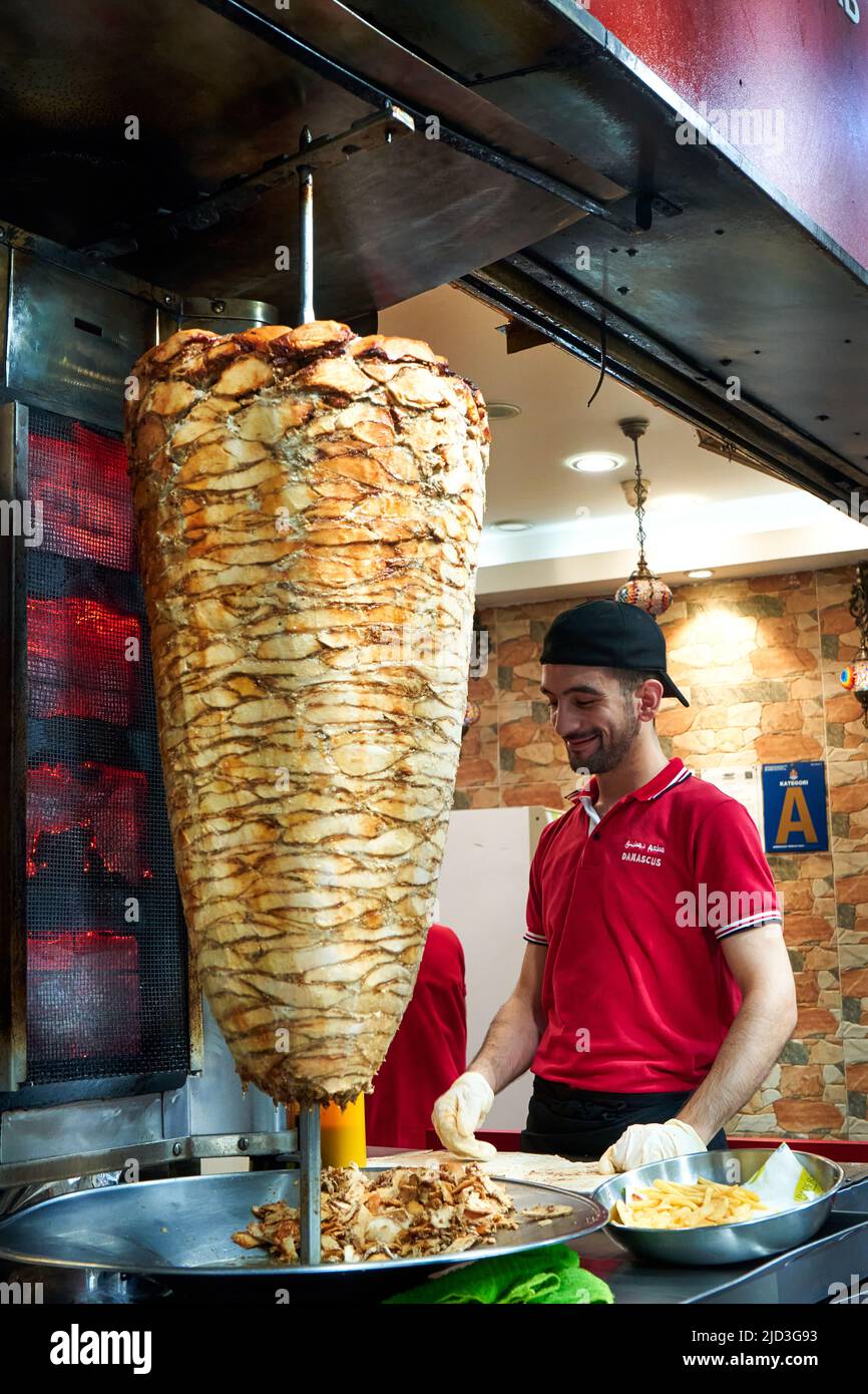 Shawarma street food counter. Meat frying on pole, while cooking. Kuala ...