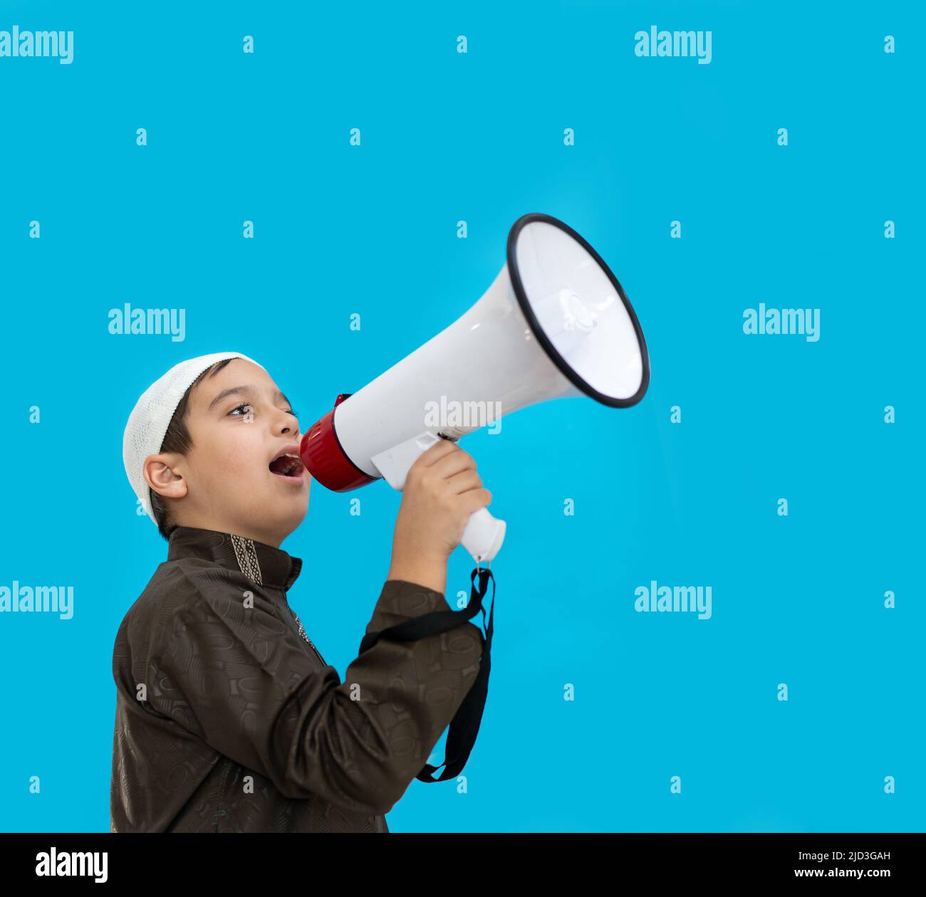 Little boy using megaphone shouting on blue background. High quality ...