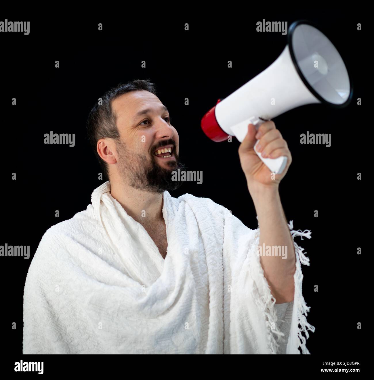 Handsome man with beard shouting through megaphone for Hajj in Mekkah ...
