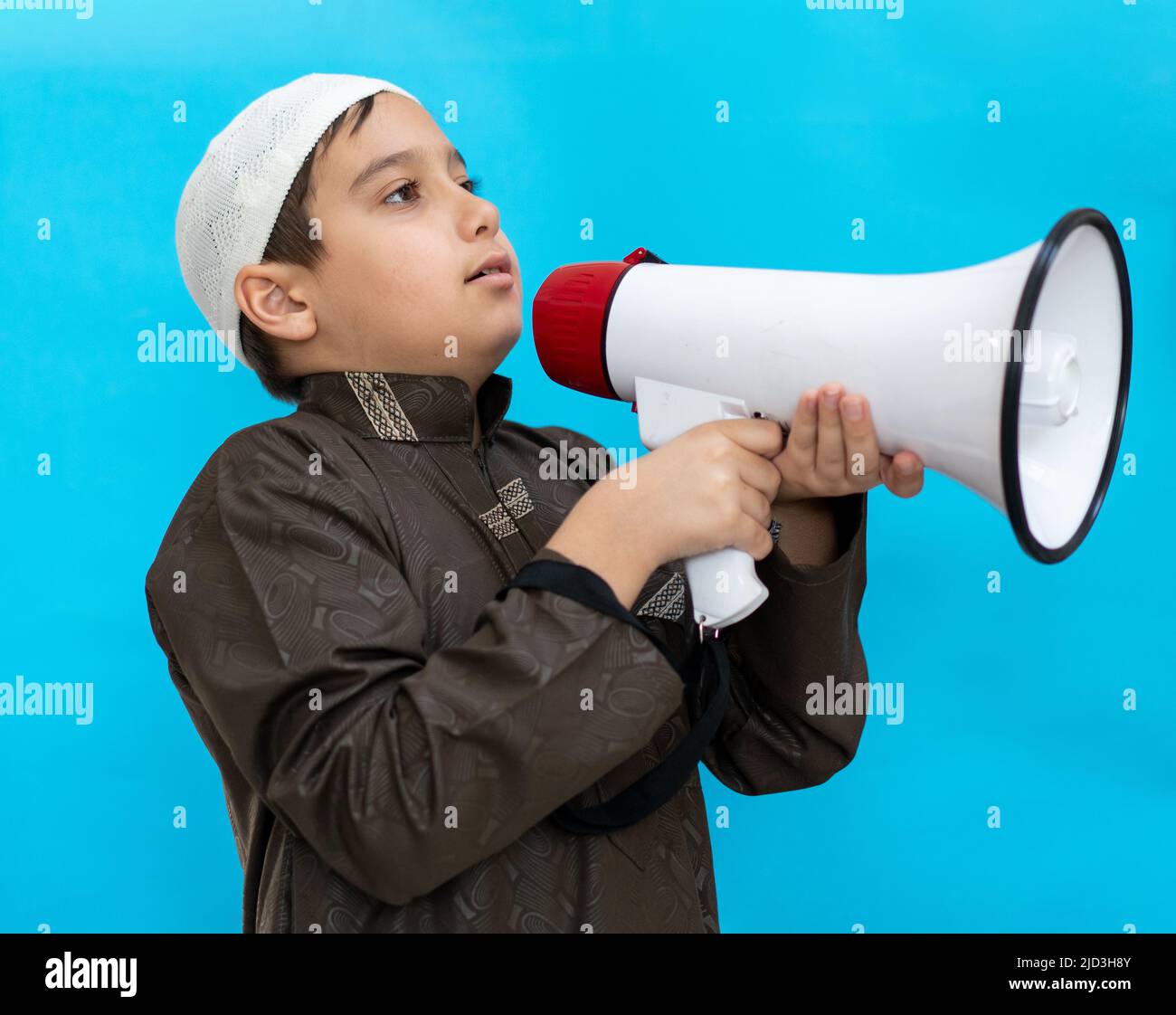 Little boy using megaphone shouting on blue background. High quality ...