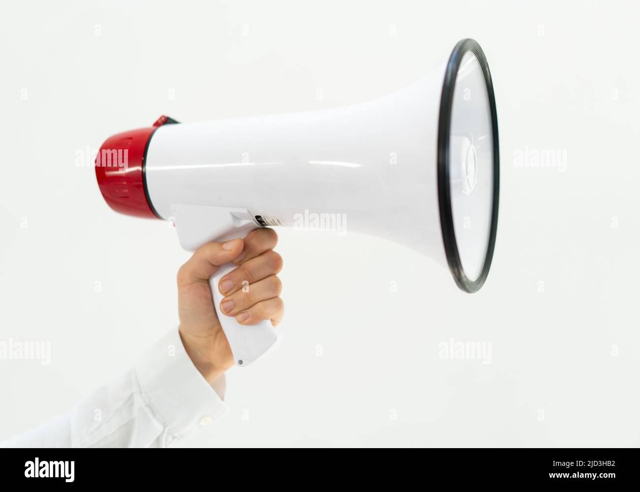 Hand of man holding megaphone over isolated white background. High ...