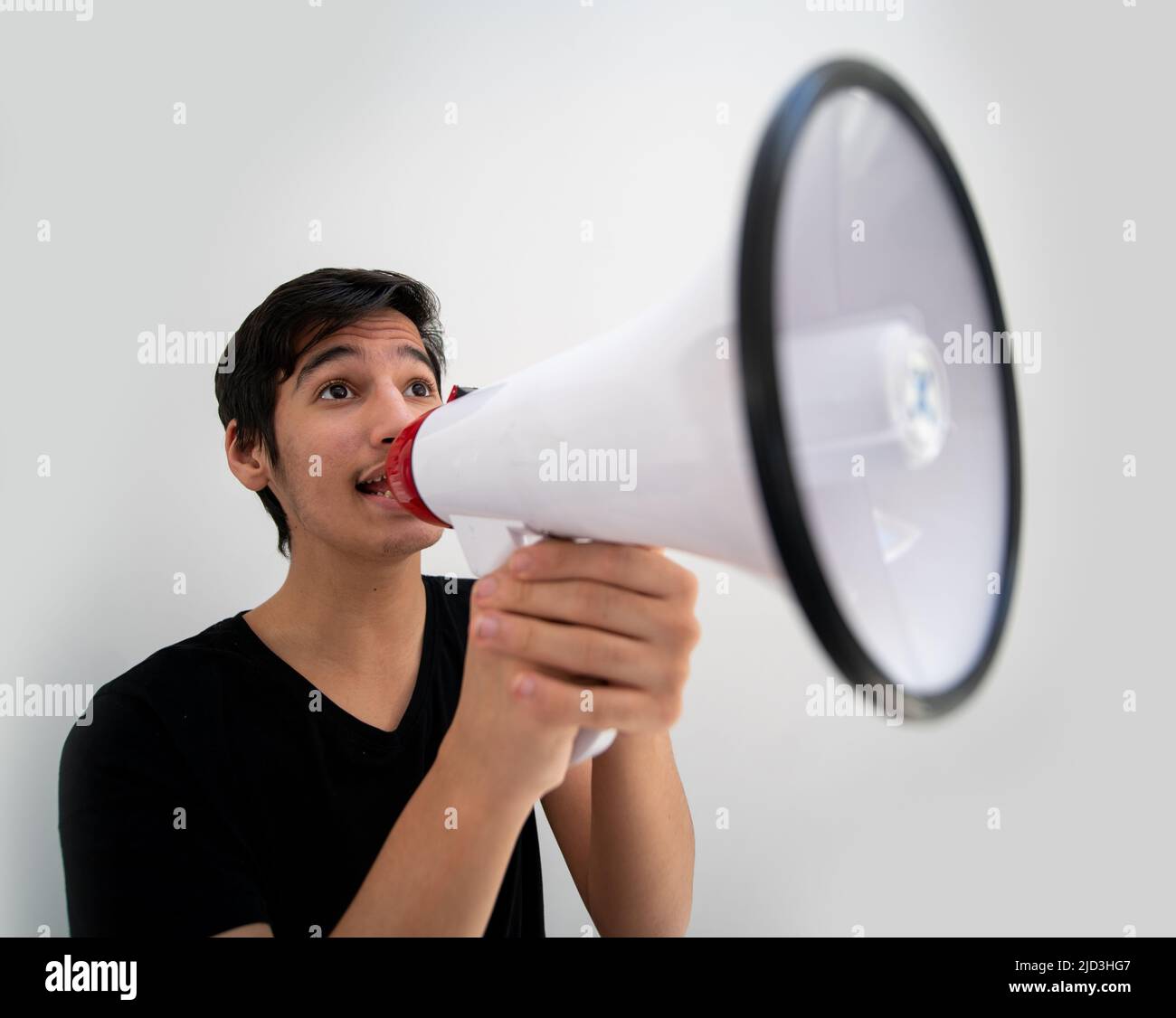 Teenage boy on white background with a megaphone. High quality photo ...