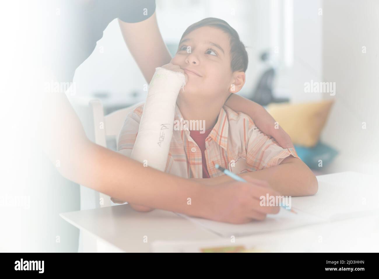 Boy with broken arm in gypsum having help from older brother for ...