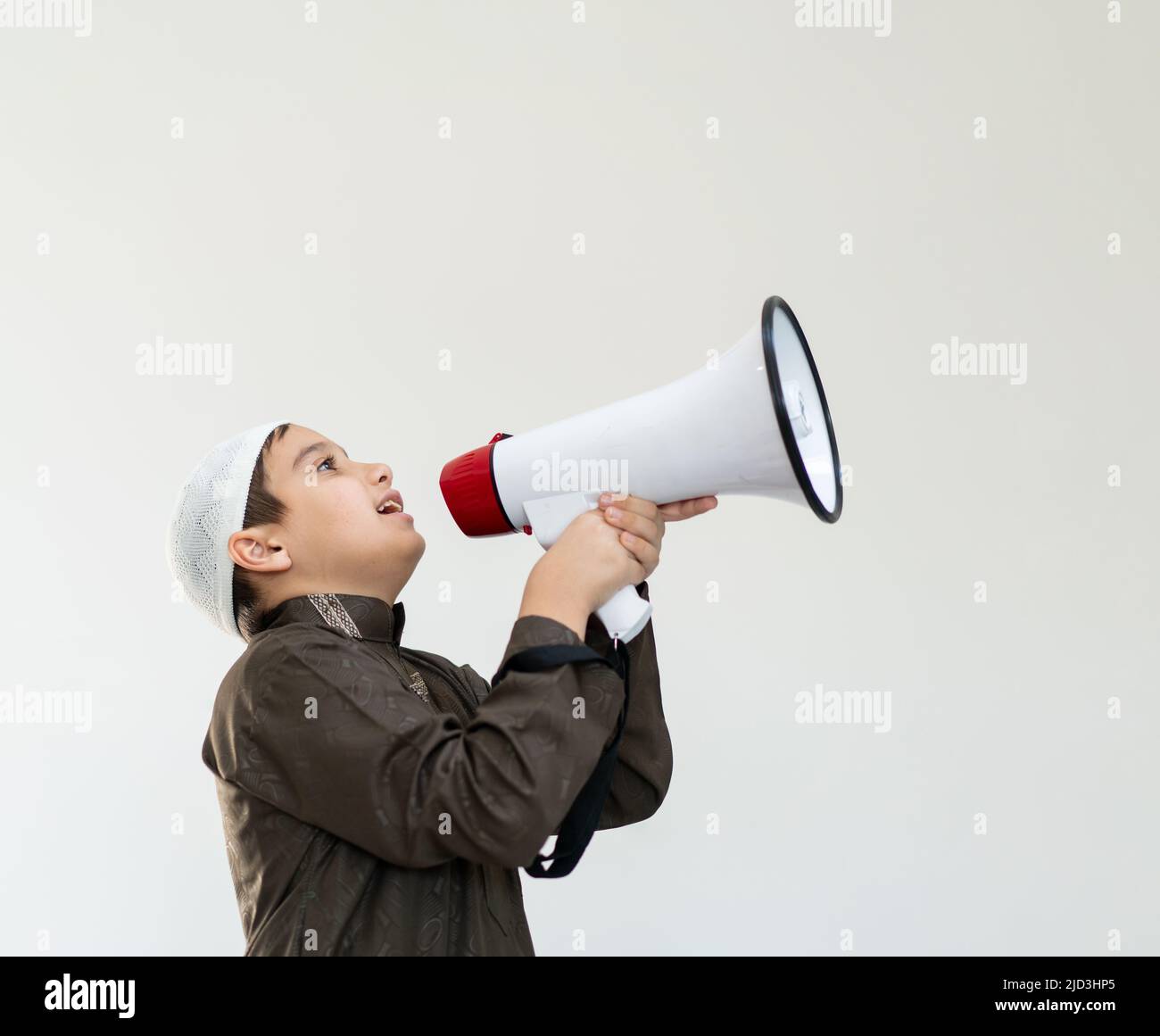Little boy using megaphone shouting on blue background. High quality ...