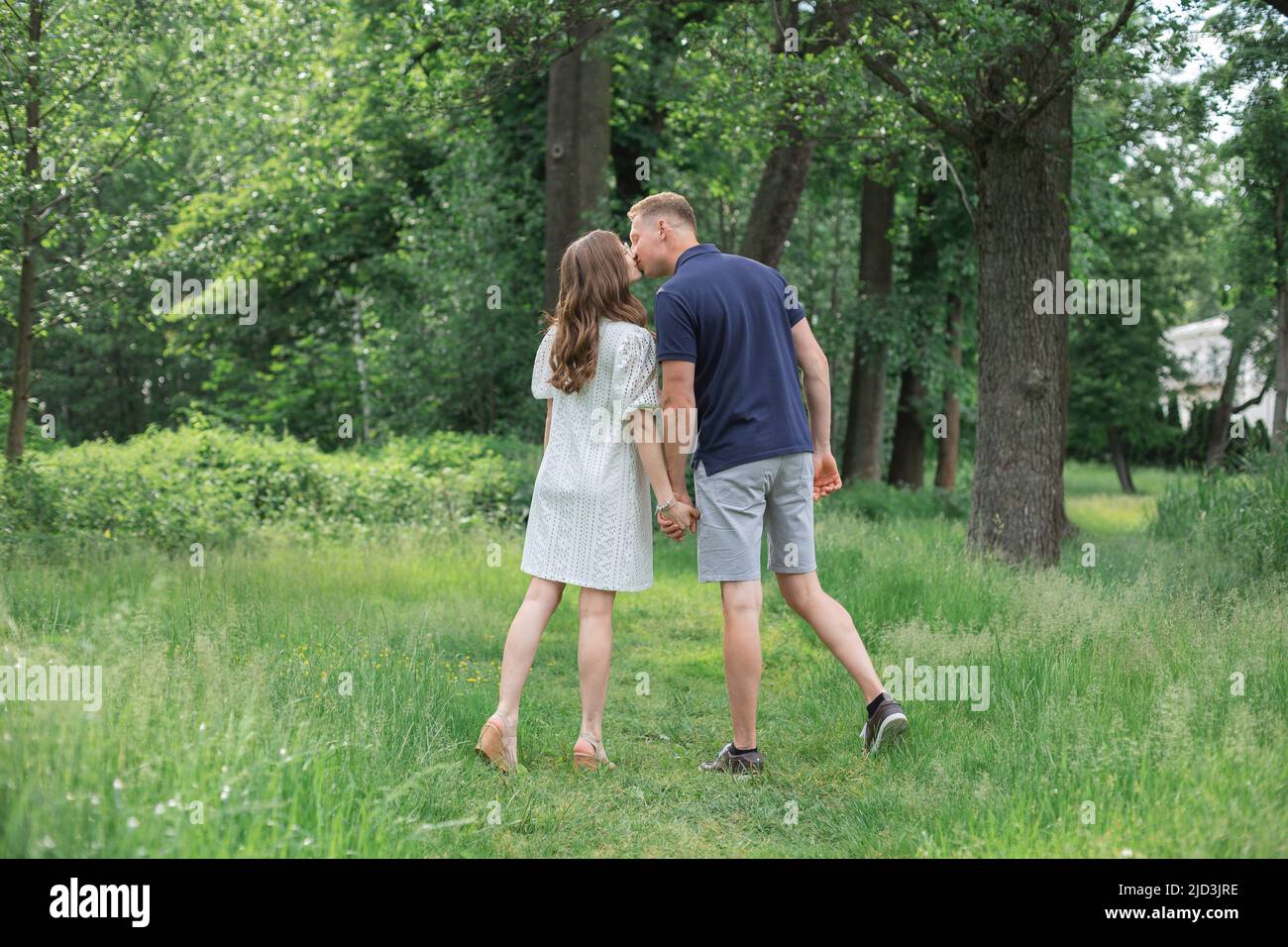 Side back view full length portrait of passionate romantic young couple ...