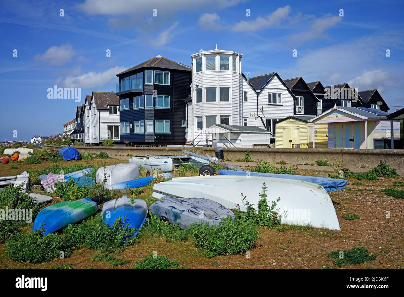 UK, Kent, Whitstable Beach, Overturned Boats and Apartments Stock Photo ...