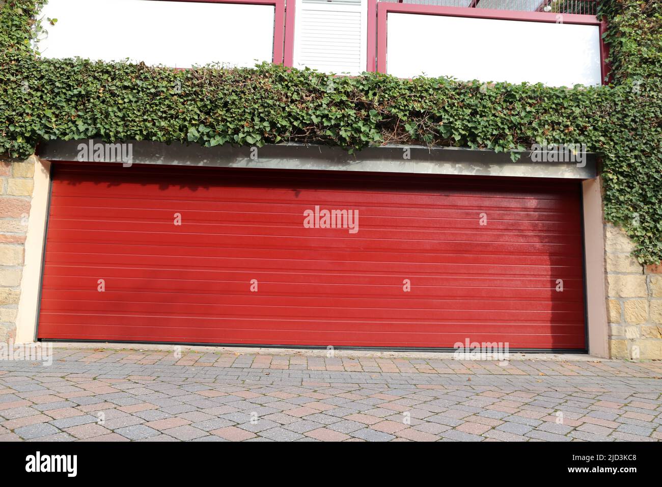 Modern red garage door (sectional door Stock Photo - Alamy