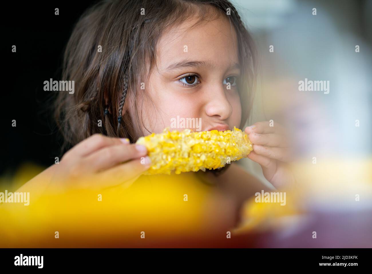 Summer snack, little boy sitting and eating corn High quality photo ...
