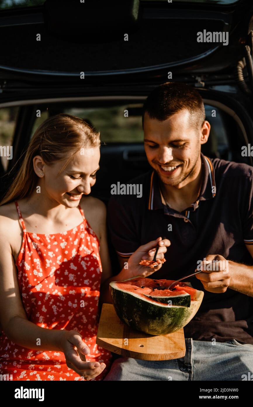 Young happy loving couple embracing and having fun together in car ...