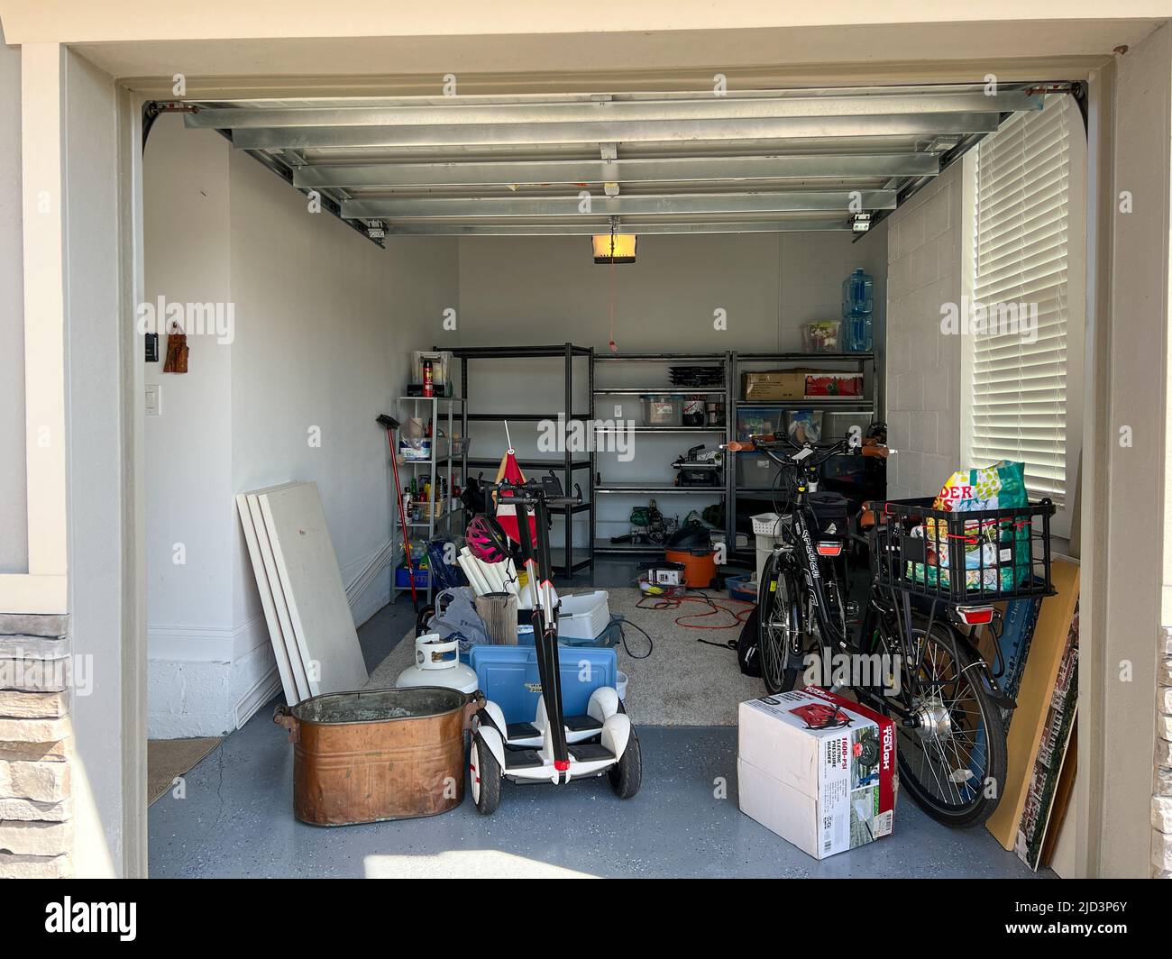 Orlando, FL USA - March 3, 2022: An unorganized garage filled with a ...