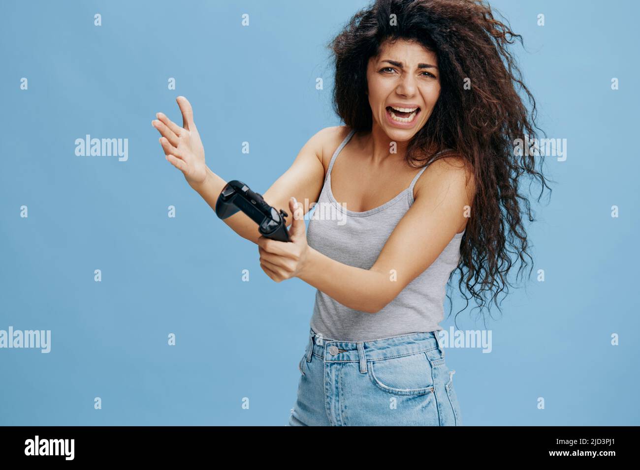 ONLINE GAME AD CONCEPT. Irritated by defeat pretty curly Latin lady ...
