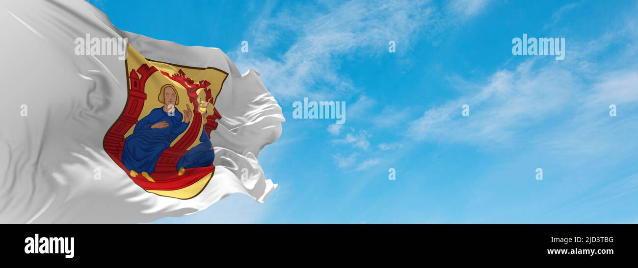 official flag of Viborg , Denmark at cloudy sky background on sunset ...