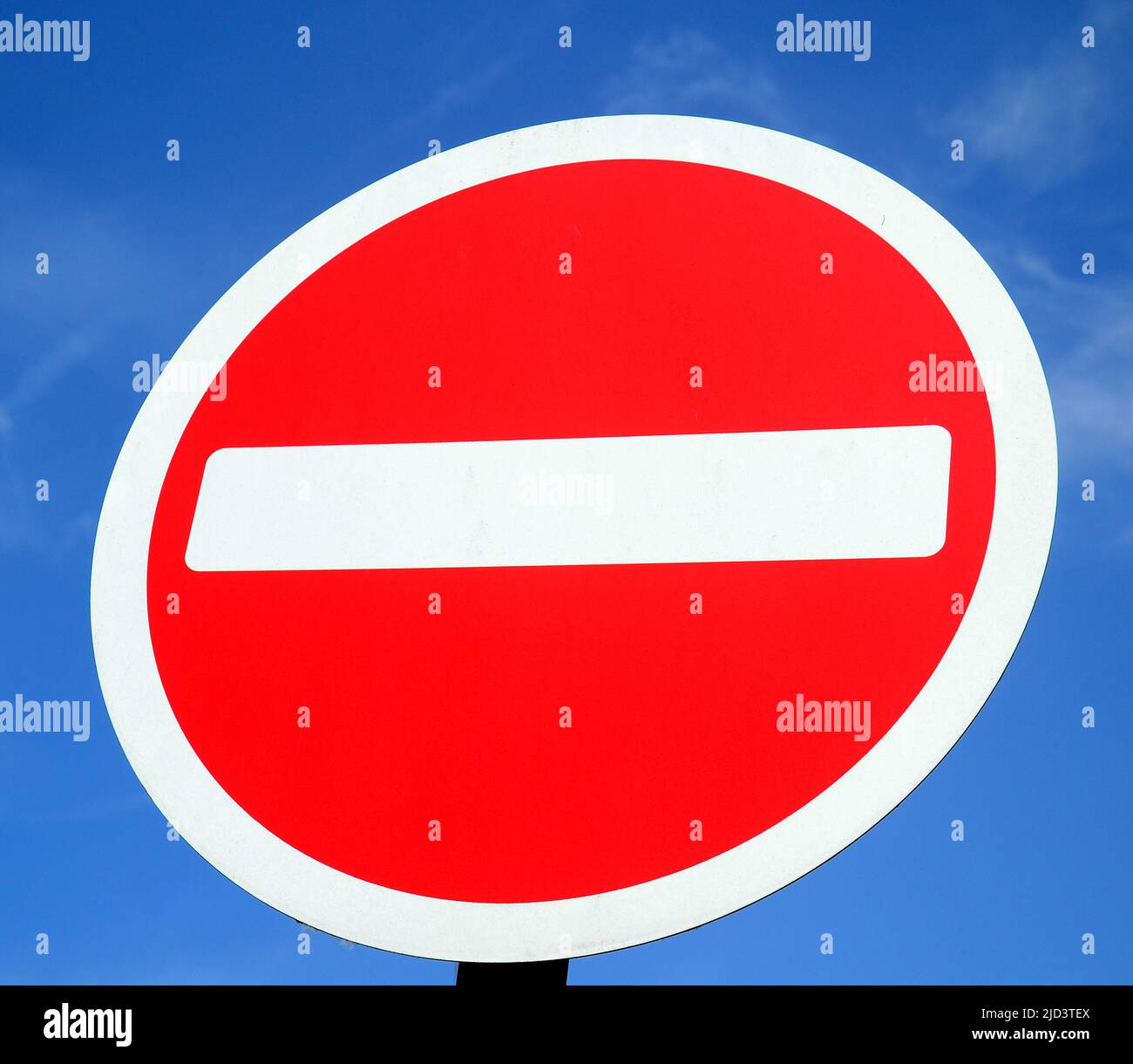 A round no entry traffic sign against a background of blue sky in ...