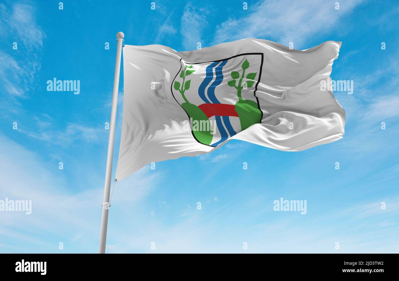 official flag of Vejle Kommune , Denmark at cloudy sky background on ...