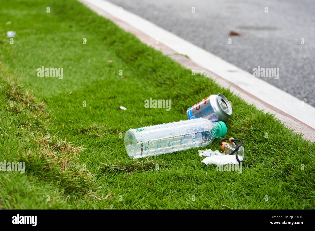 Plastic bottle and some litter on the roadside Stock Photo - Alamy