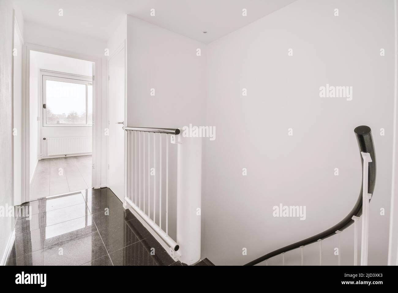 Light hallway with entrance door in two level apartment with minimalist ...