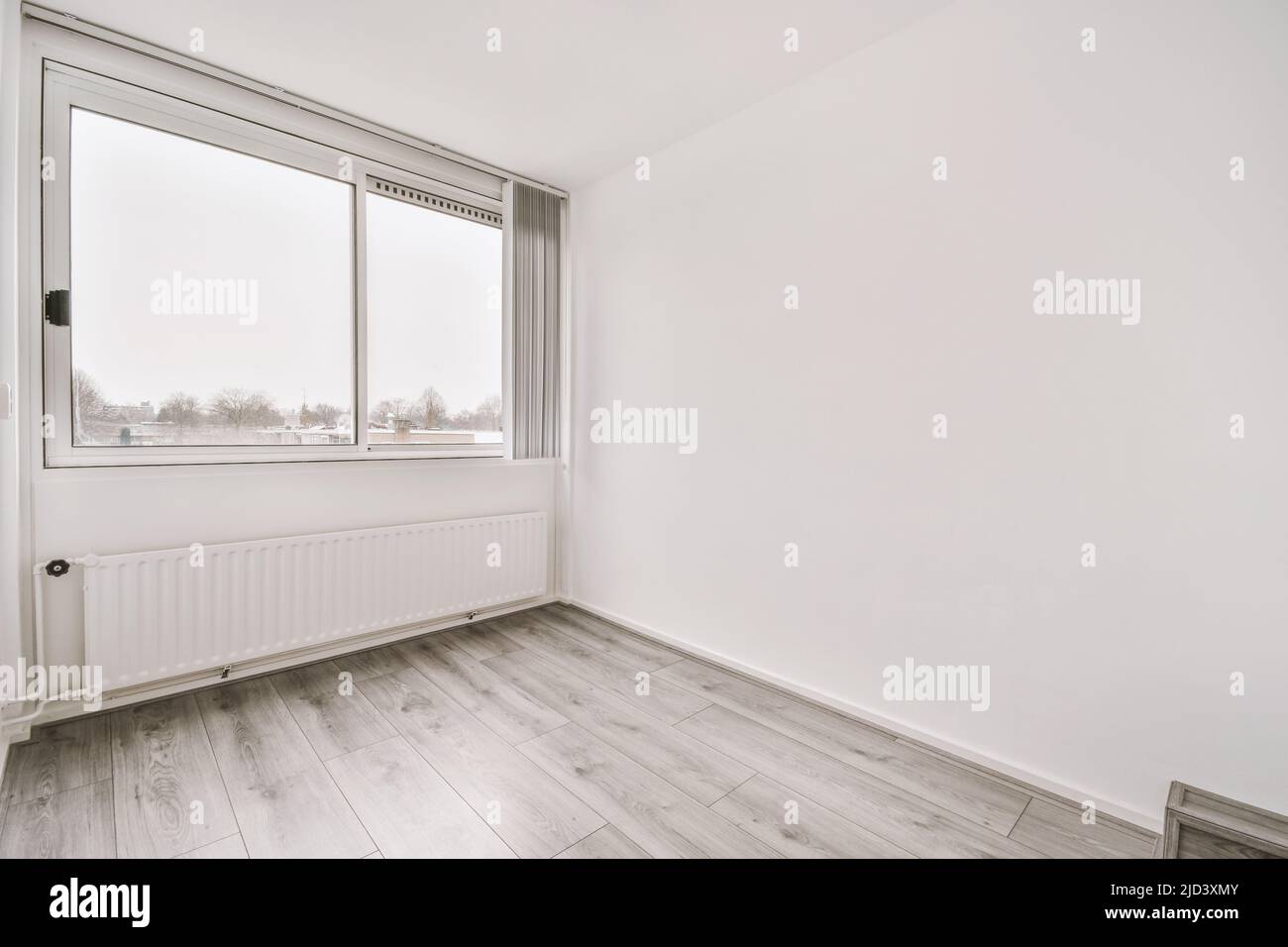 Interior of empty white room with large windows with jalousie and ...