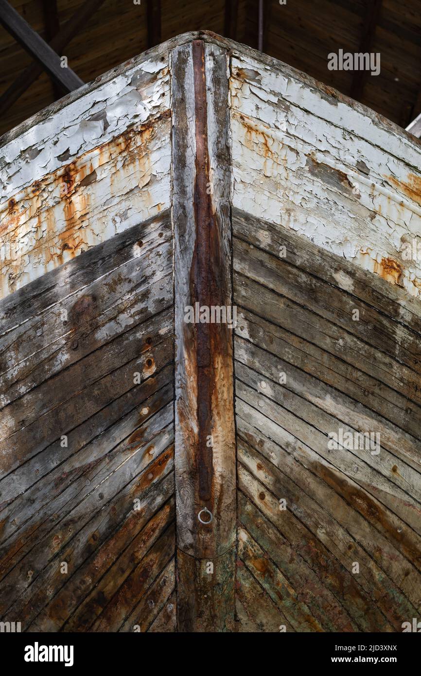 A head-on image of the bow of an old boat pulled up on land Stock Photo ...