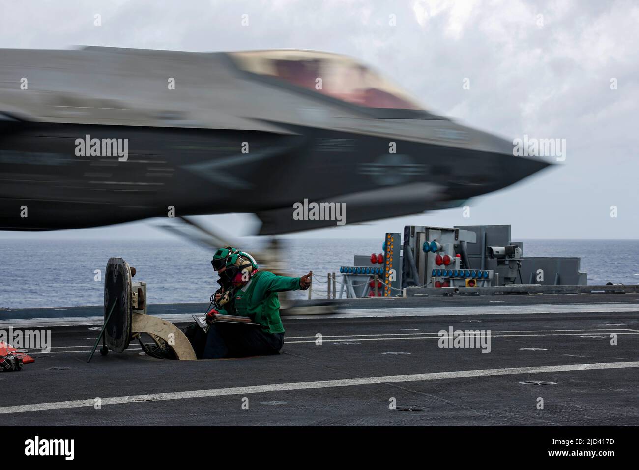 PHILIPPINE SEA (June 15, 2022) Sailors direct the launch of an F-35C Lightning II, assigned to ...