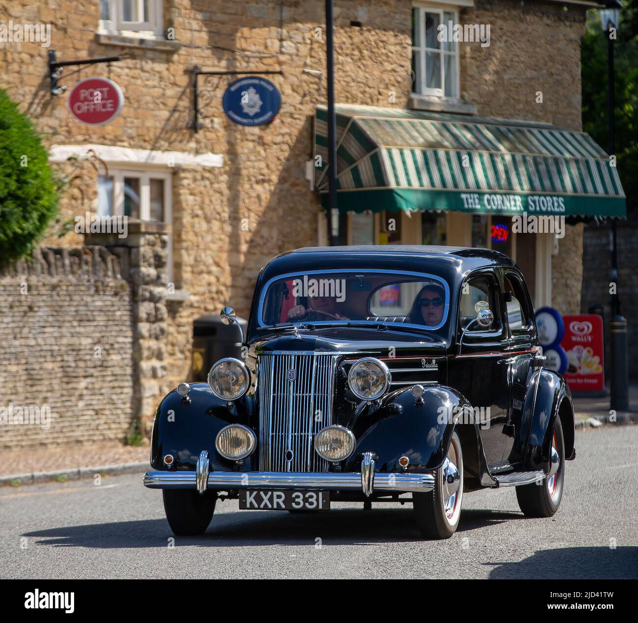 1950 Ford V8 Pilot driving through an English village Stock Photo - Alamy