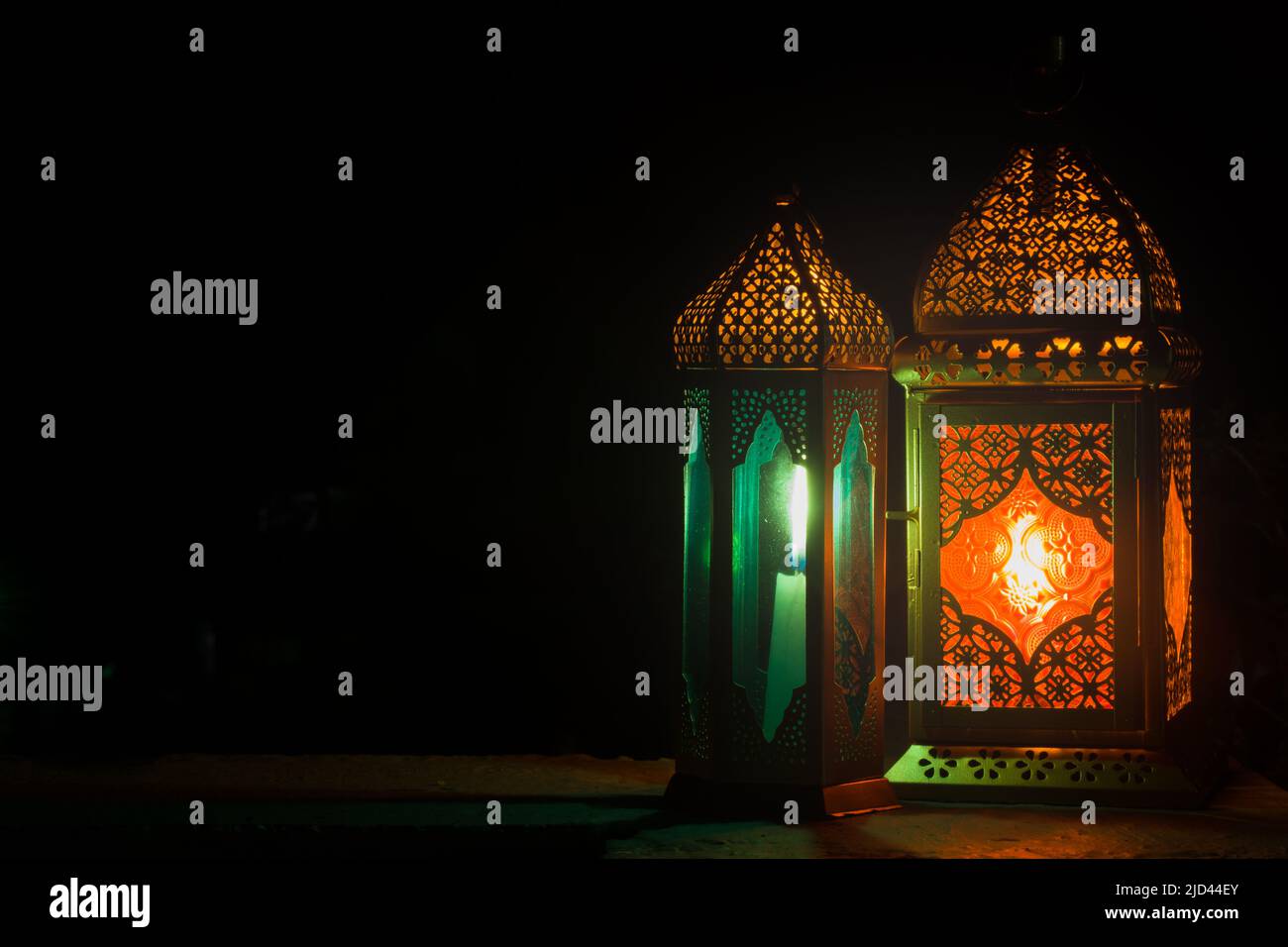 Ornamental Arabic lantern with a burning candle glowing at night ...
