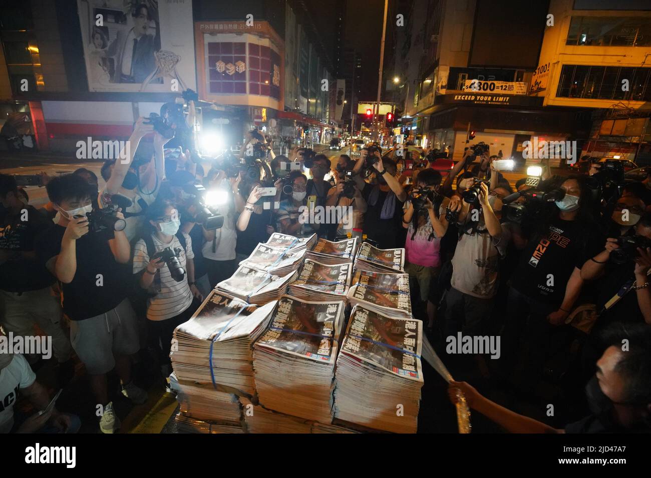 Journalists take photos of the last edition of Apple Daily newspapers ...