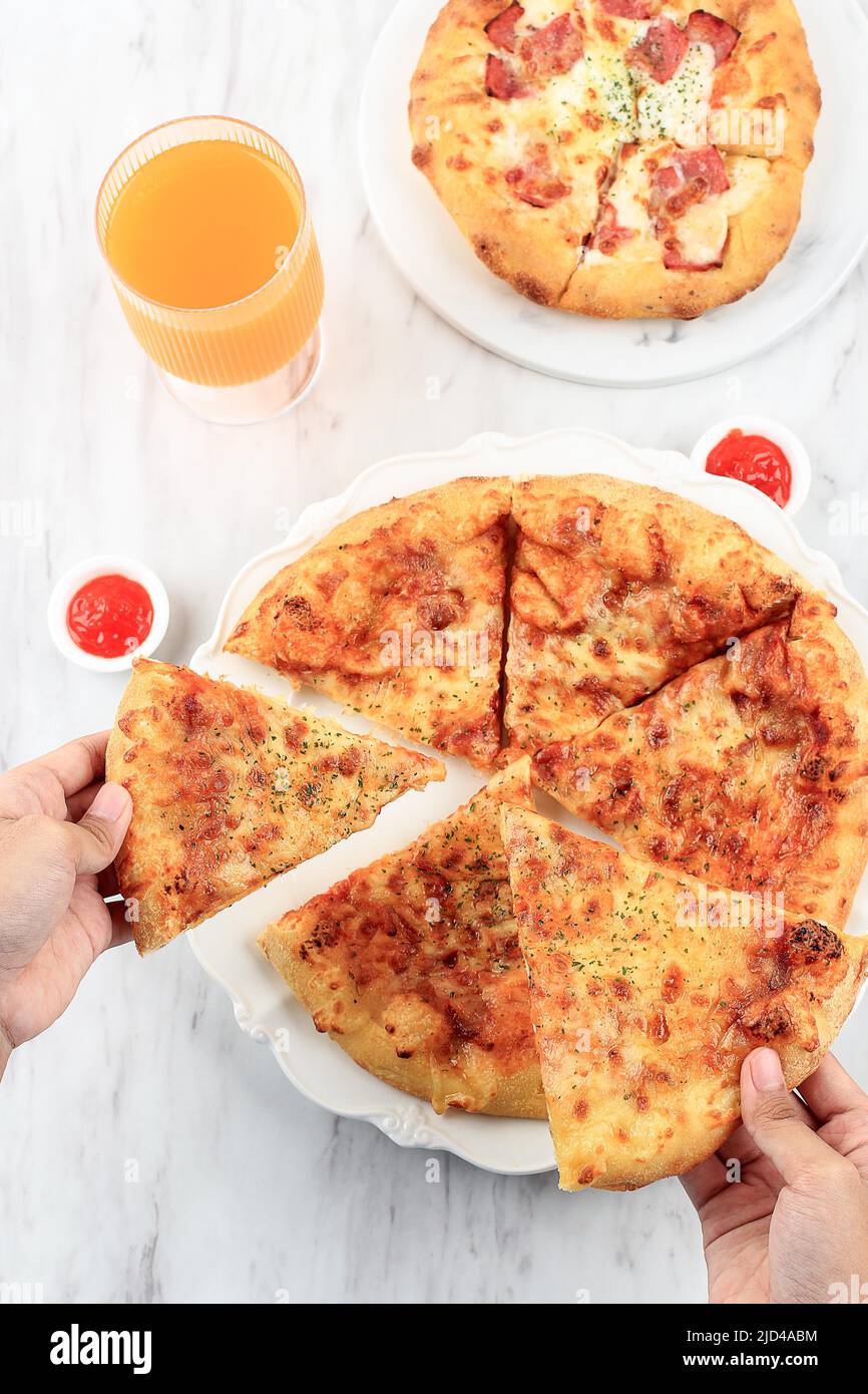Hand Taking Slice Pizza on White Table Stock Photo - Alamy