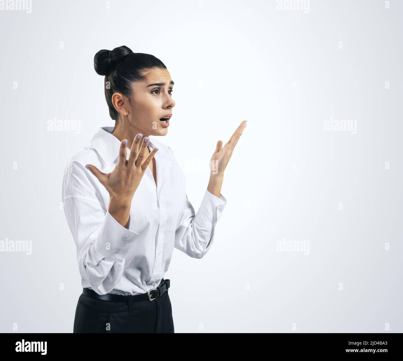 Crisis concept with indignant young woman in white shirt with rising up ...