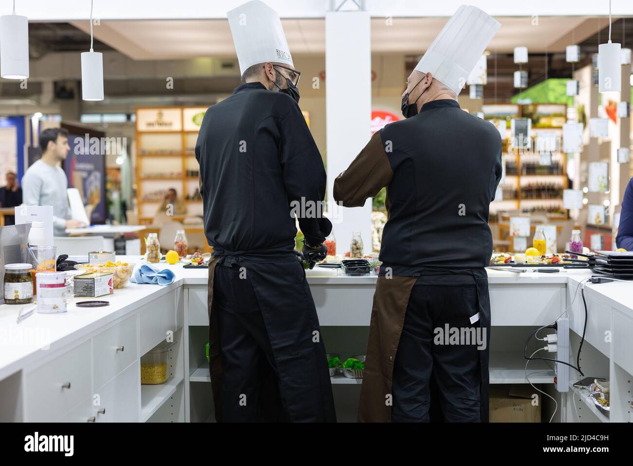 Two Chefs seen from behind: serving Diners Behind their Table Stock ...