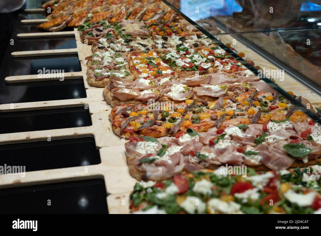 Display of a Bakery Counter with Stuffed Pizzas in many Tastes Stock ...