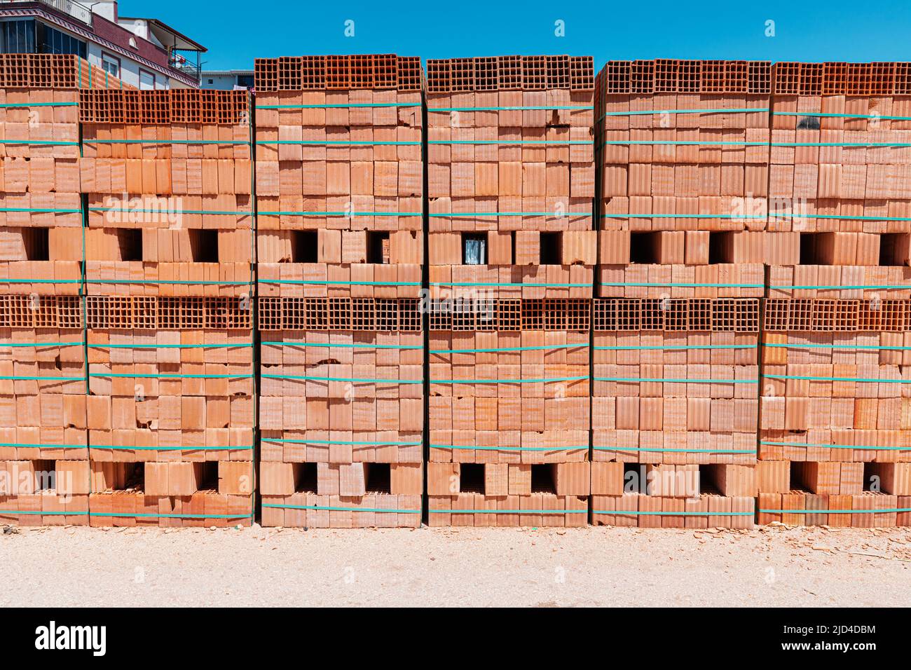 Pallets with freshly made racks of bricks at a construction site or ...