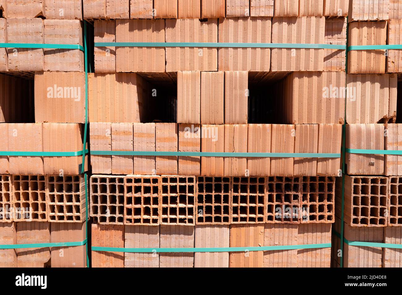 Pallets with freshly made racks of bricks at a construction site or ...