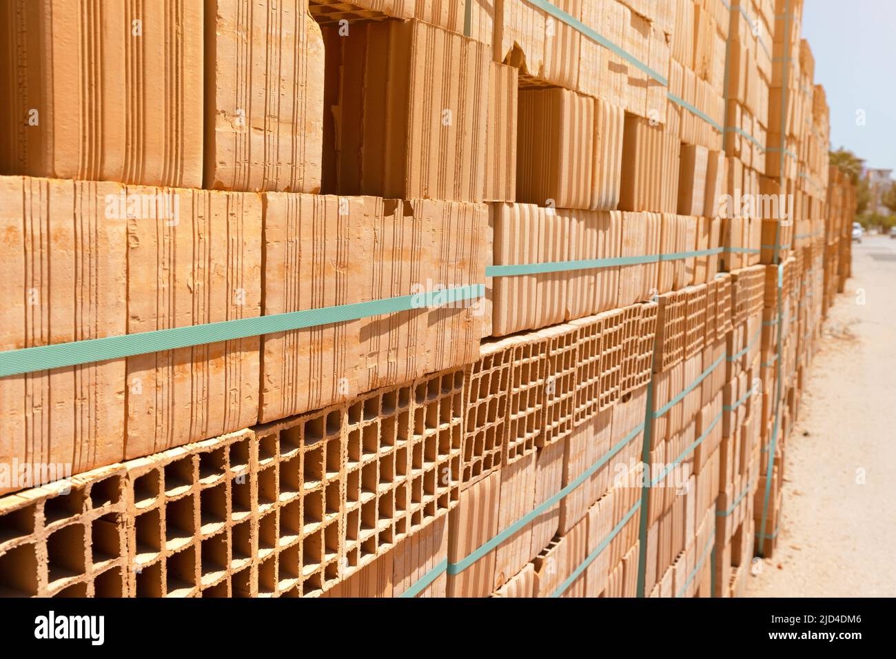Pallets with freshly made racks of bricks at a construction site or ...