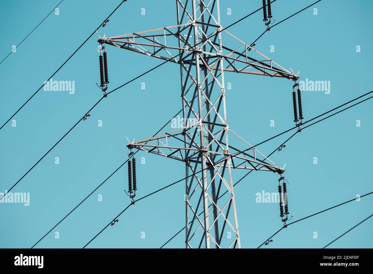 An electric pole with wires transmits energy to consumers ...