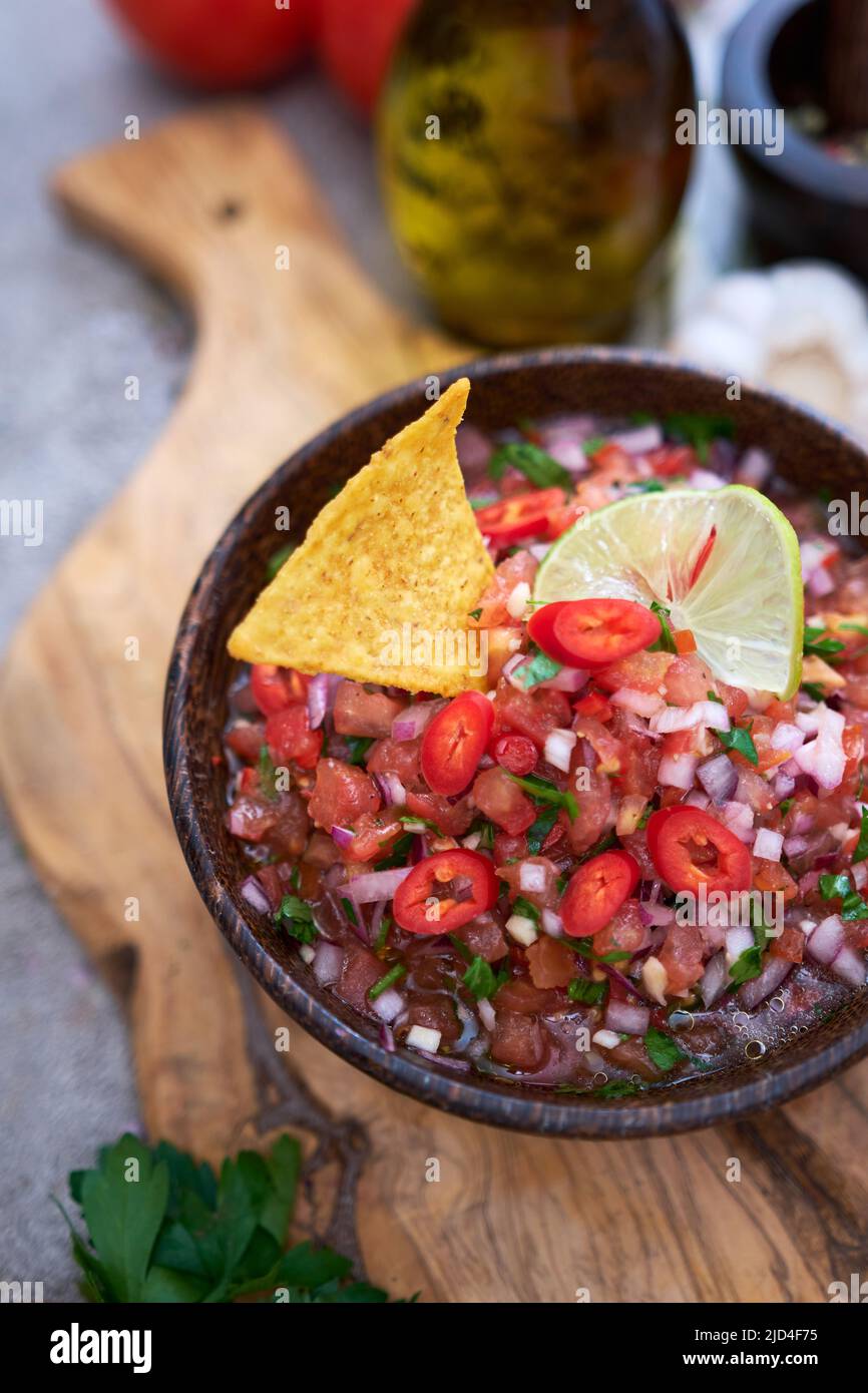 freshly made salsa dip sauce with nacho chips on wooden board Stock ...