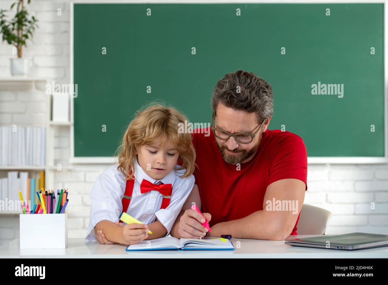 Kid boy learning with teacher. Funny little boy study with father in ...