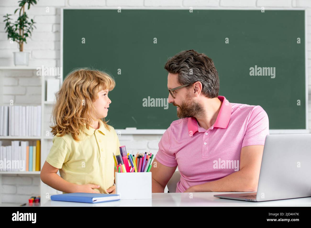 Pupil kid student and teacher tutor in classroom at school lesson ...