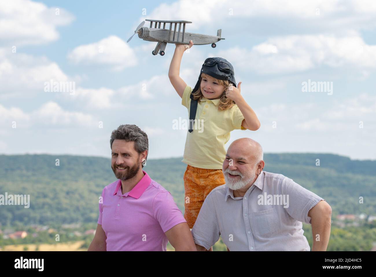 Men generation: grandfather father and grandson playing with toy plane ...