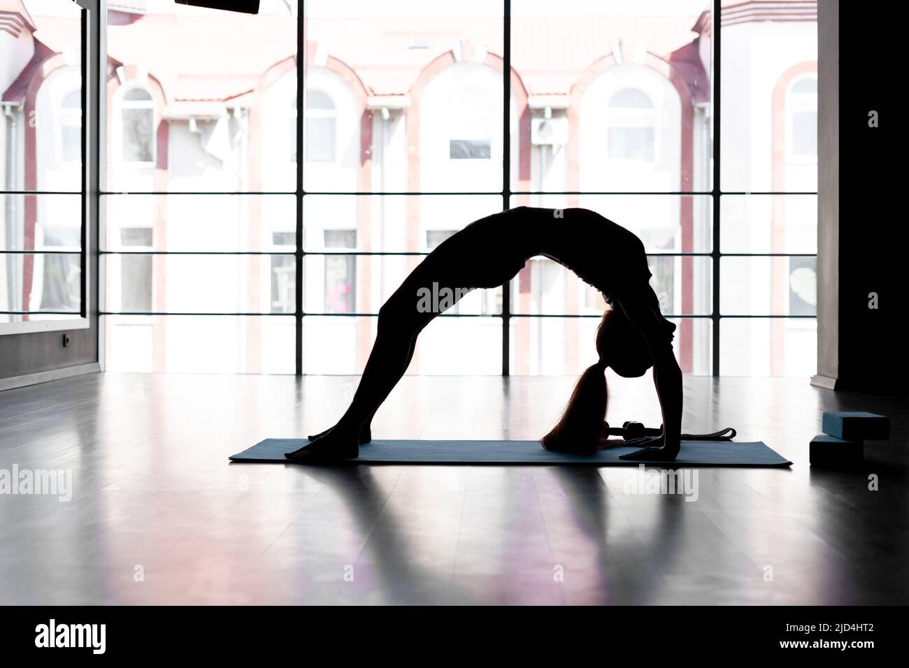 silhouette of a yogi woman doing elbow bridge exercises, Dwi Pada ...