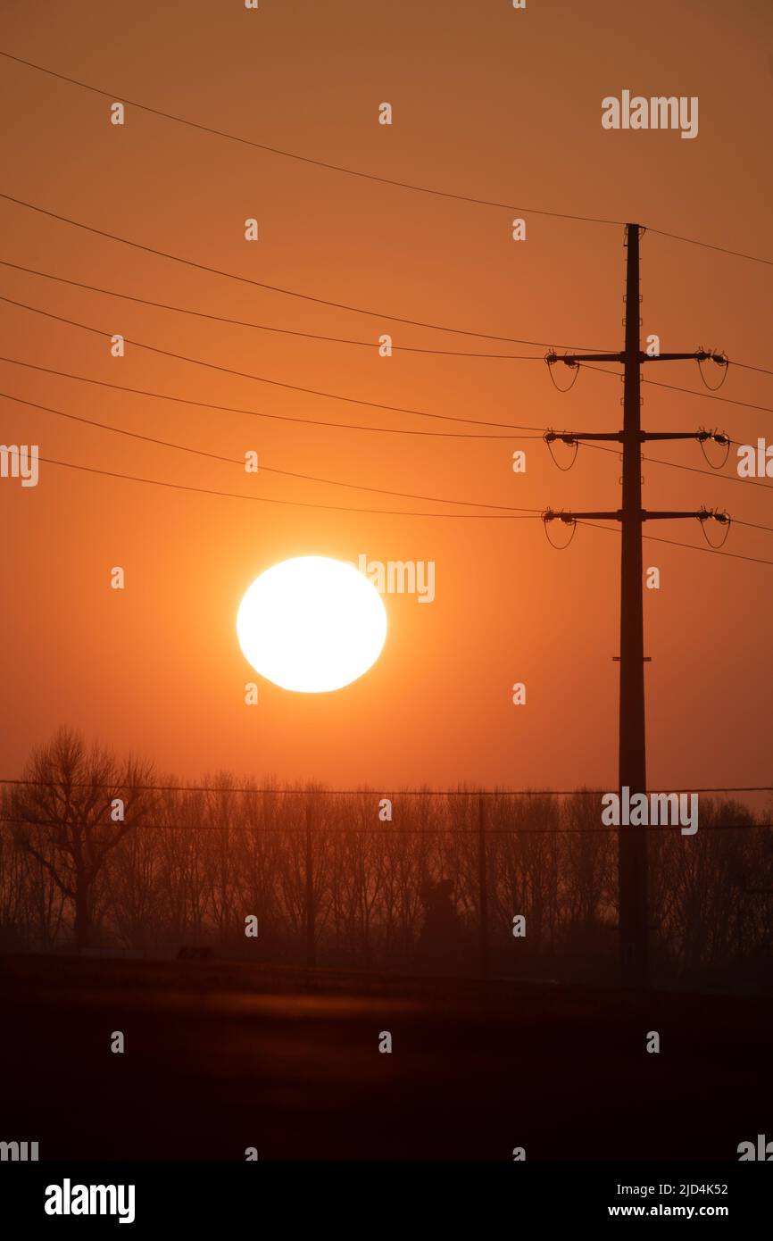 Harnassing the power of sun. Telephoto of a setting sun, contrasted ...