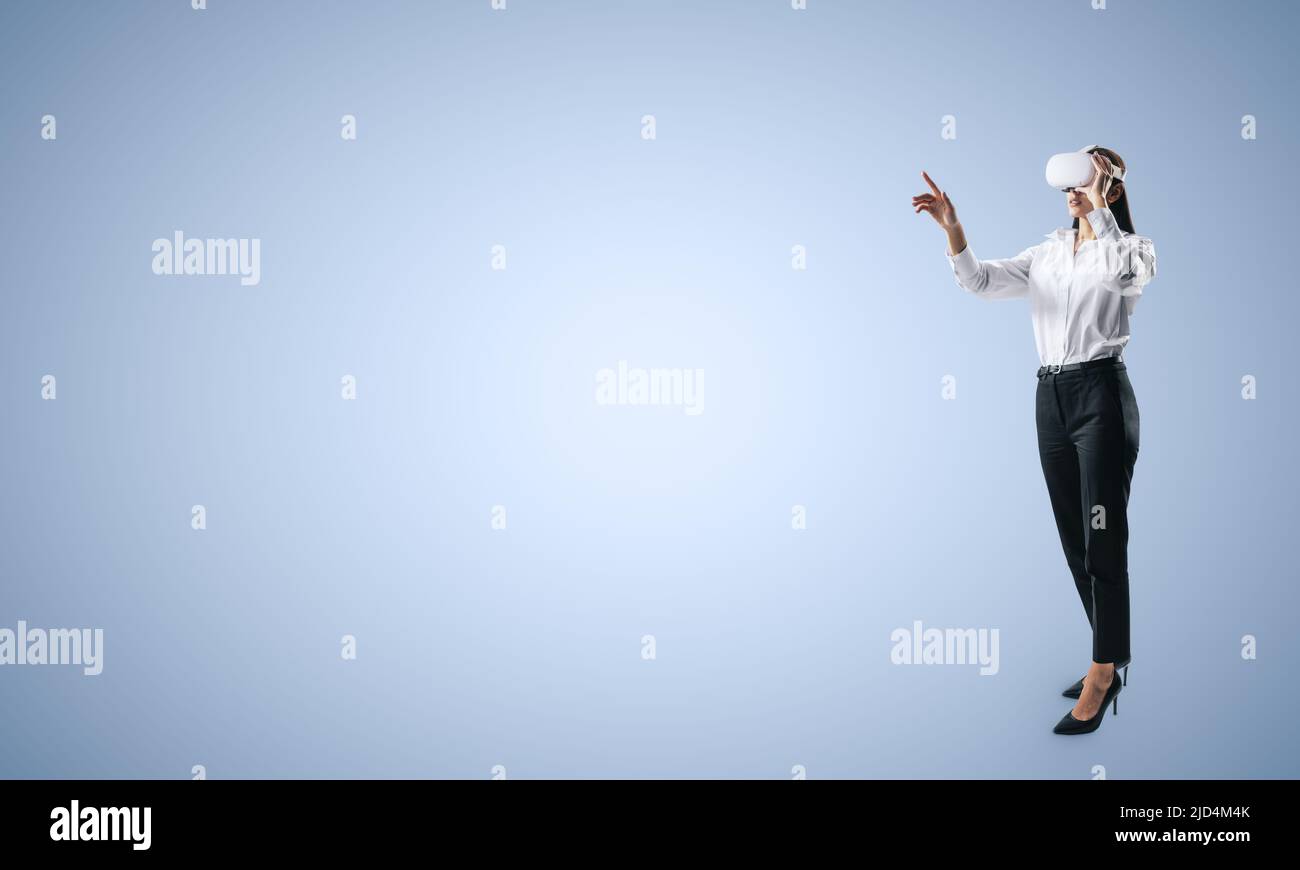 Woman full length standing and working in virtual reality environment ...