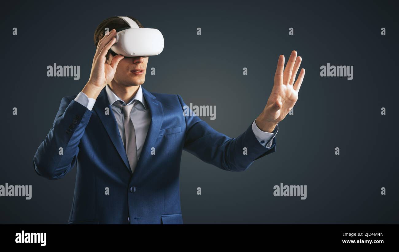 Young businessman working in virtual reality office in VR glasses ...