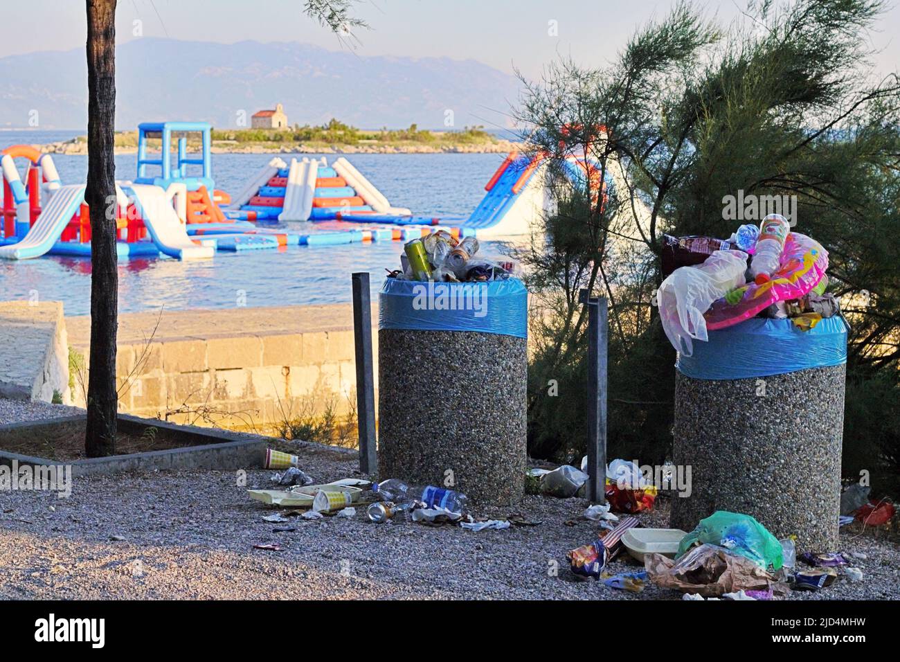overspilled trash can on the beach Stock Photo - Alamy