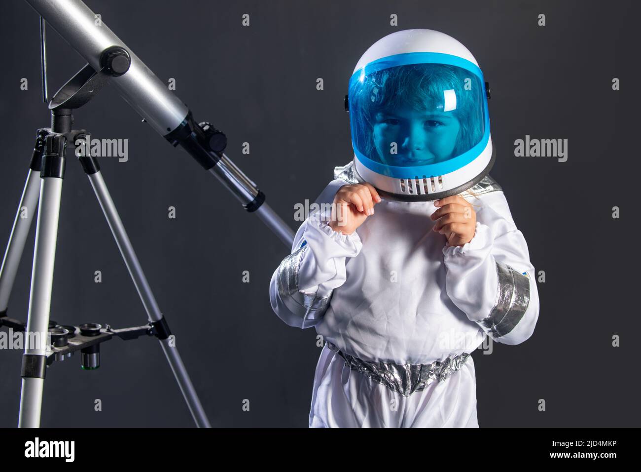 Space kids cosmonaut concept. Portrait of positive little boy with a ...