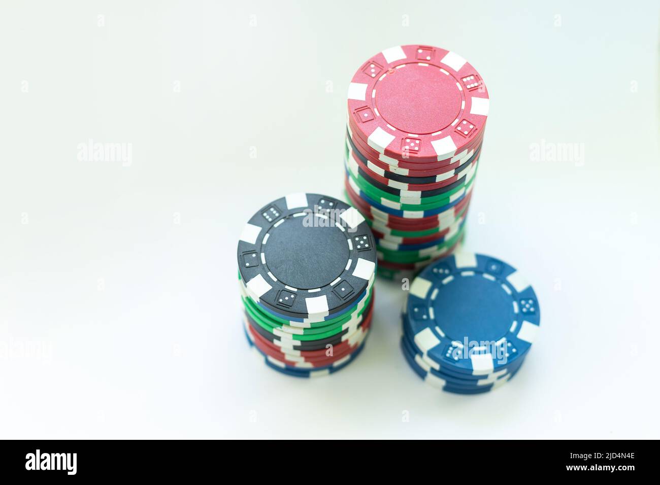 Plastic casino chips stacked on white background. Poker game Stock ...