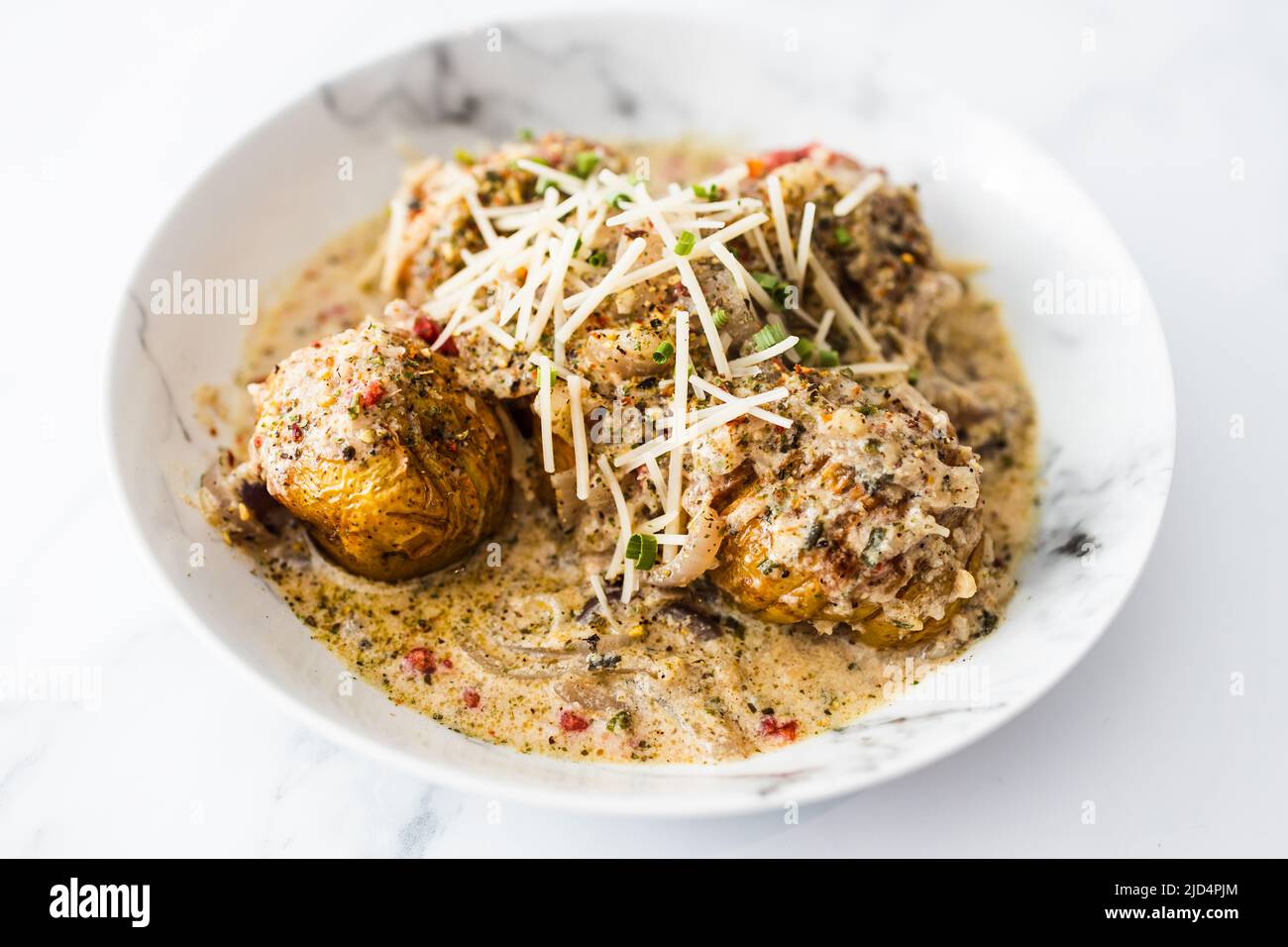 plant-based potato bake with dairy-free creamy sauce with chives nutmeg ...