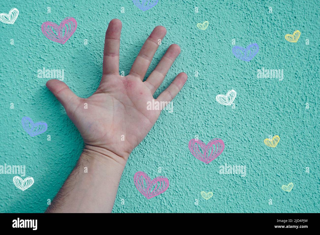 hand on the blue wall with hearts shapes, valentines's day Stock Photo ...