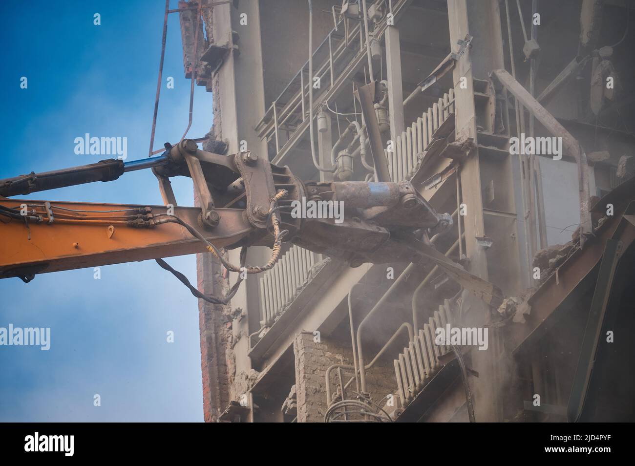 Hydraulic scissors on rig of crane cut building on site Stock Photo - Alamy