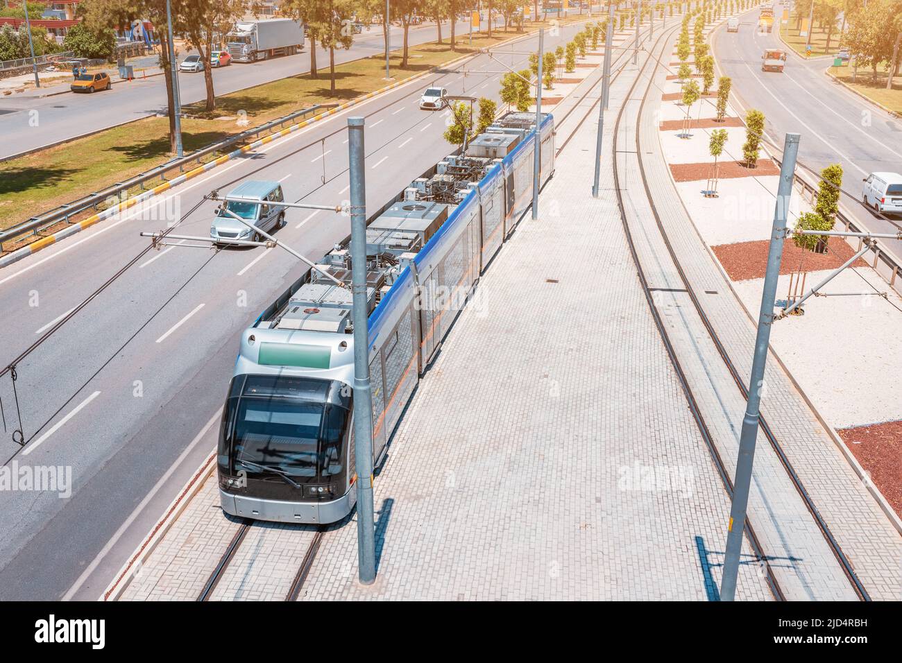 Electric eco tram runs parallel to the high-speed highway in modern ...