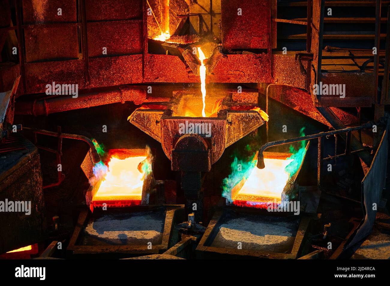 Pouring liquid copper metal for anodes into form in workshop Stock ...